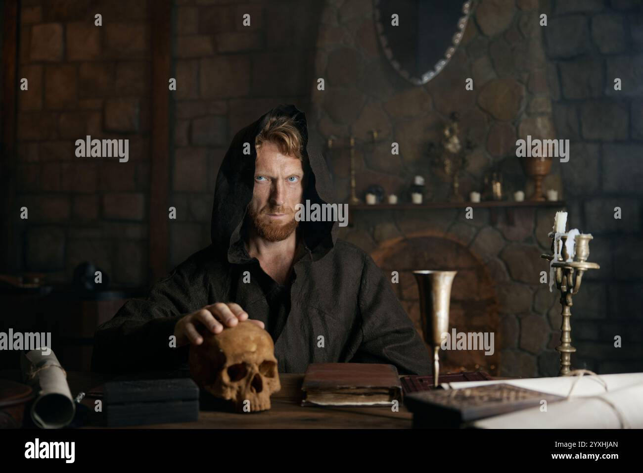 Mystical spooky medieval monk in black cassock with human skull on ...