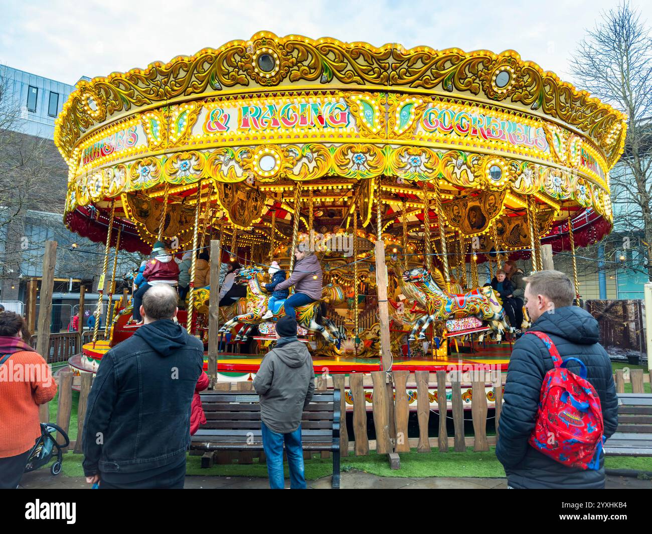 Colorful vintage carousel with ornate decorations and people enjoying ...