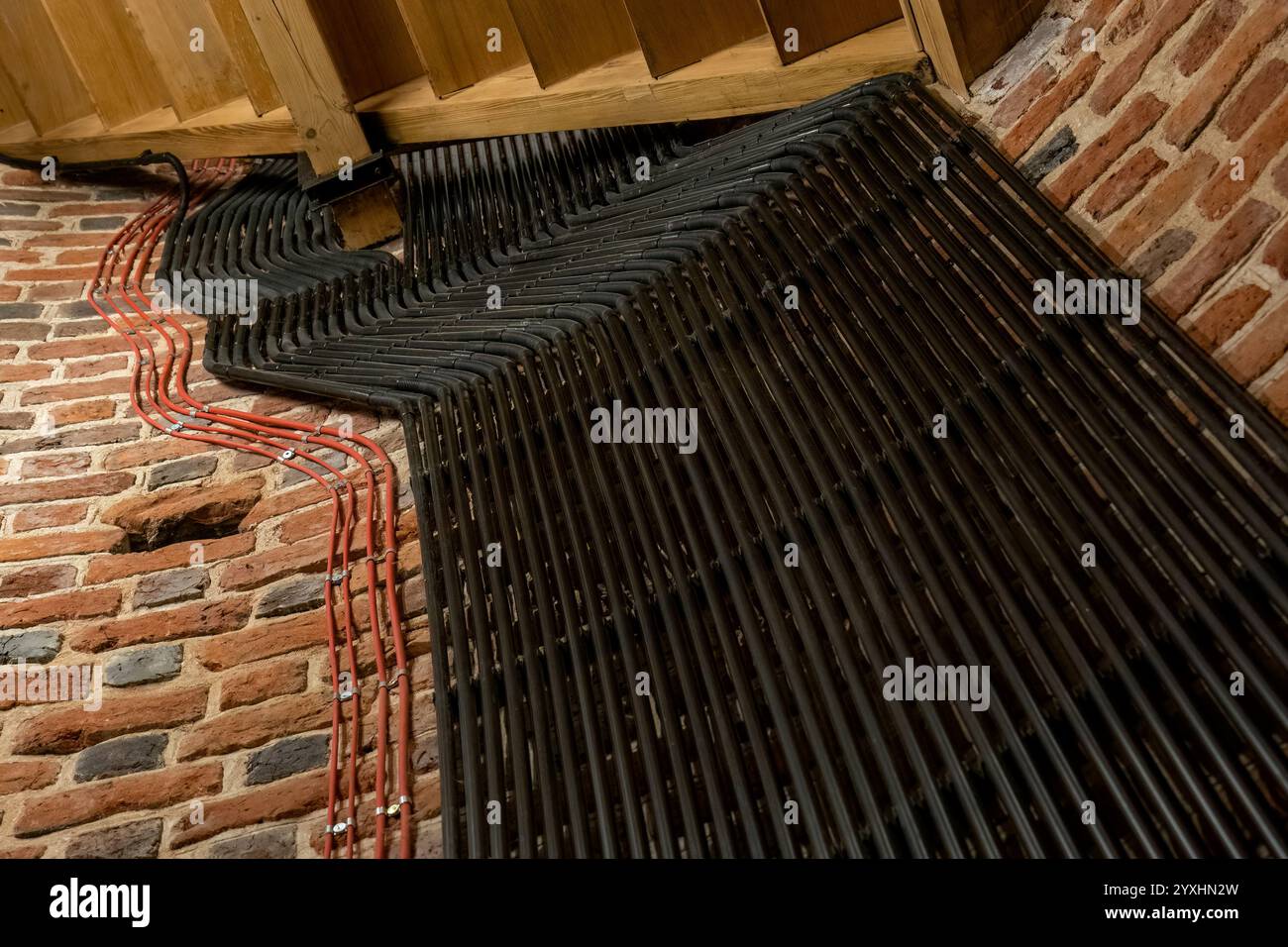 Thick shielded electrical power or data cables on s historic brick wall ...