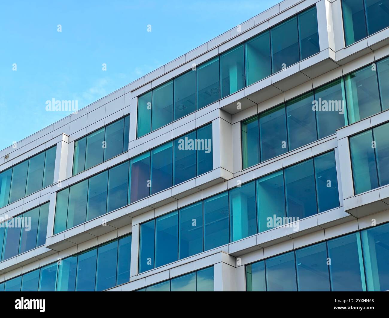 Modern corporate office building exterior with glass windows and clear ...