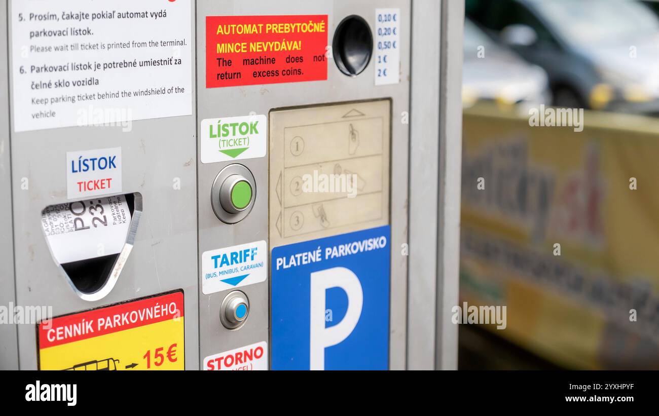 Parking ticket machine with coin slot and green button detail, close-up ...
