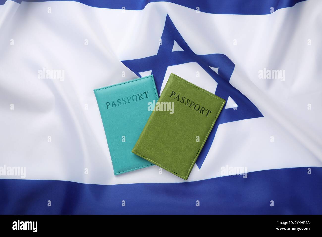 Passports in color covers on flag of Israel, top view Stock Photo - Alamy
