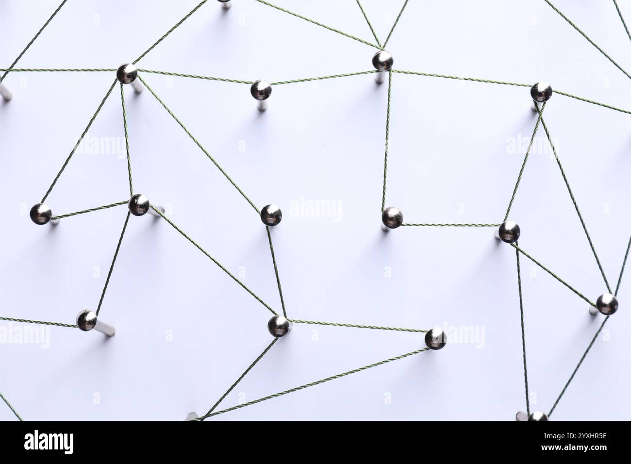 Network connection. Nails linked together by threads on white ...
