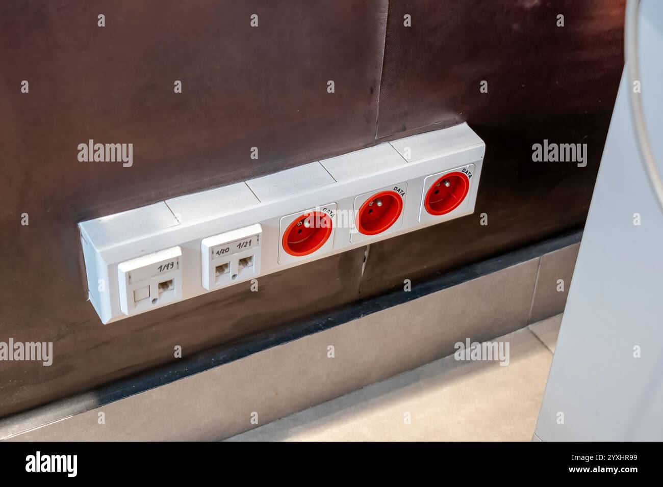 RJ45 Ethernet internet ports and red data power sockets in a row on an ...