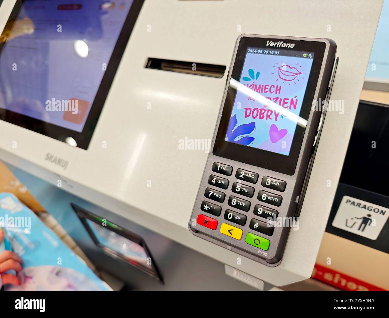 Modern wireless card payment terminal POS at self-checkout station in ...