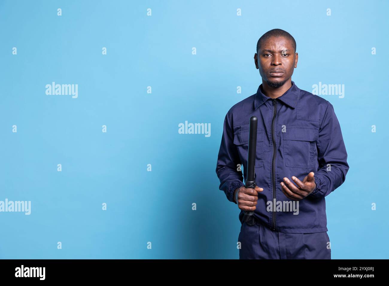 African american agent carrying a protection baton in his hands ...