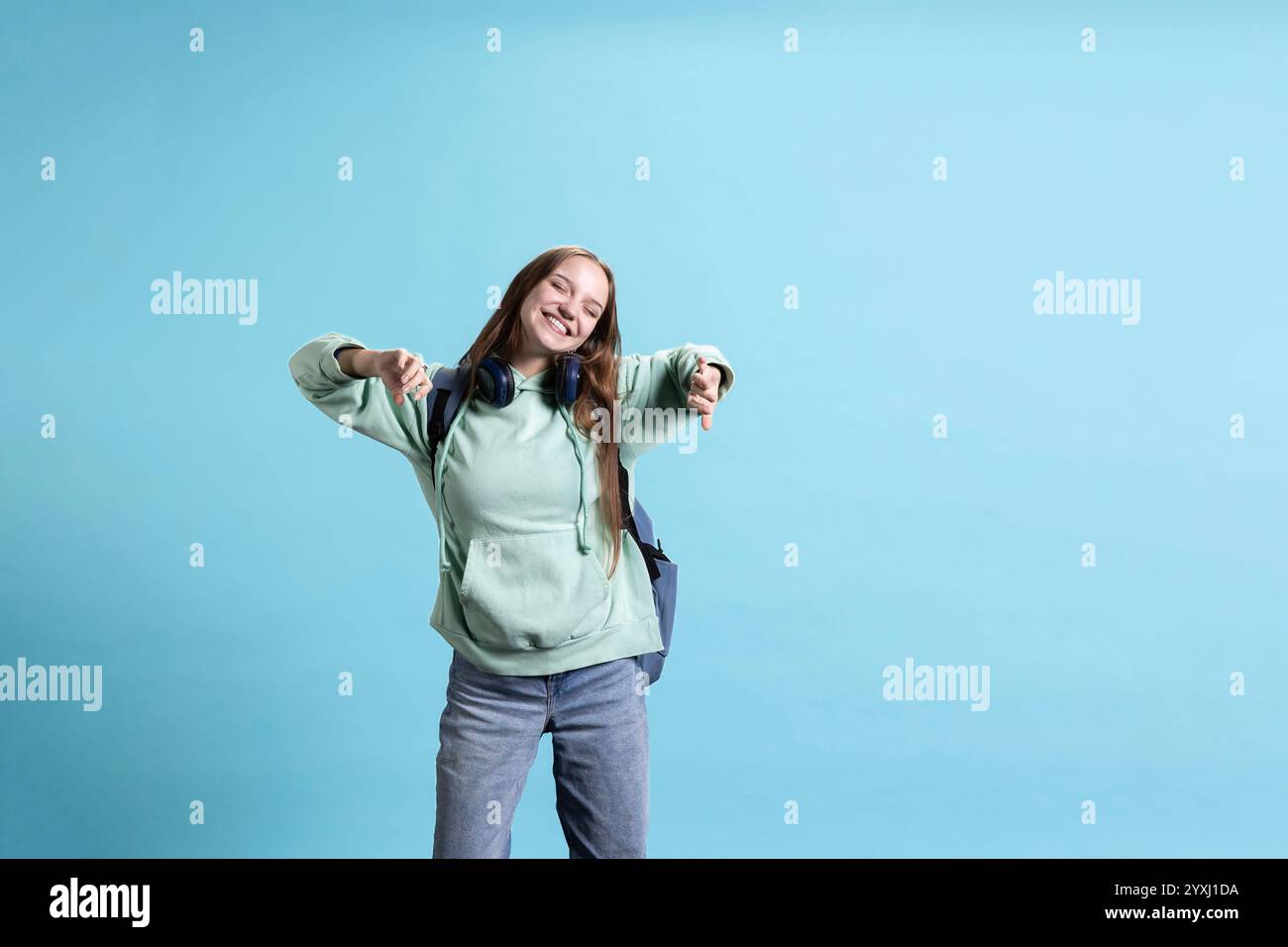 Joyous woman doing happy dance, feeling joyful, isolated over blue ...