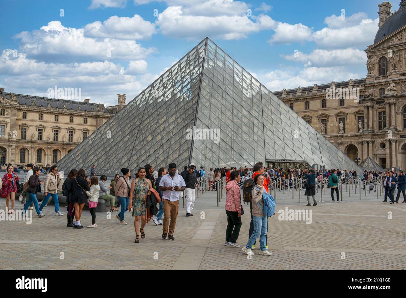 People at the Musee du Louvre with the famous glass Pyramid. One of ...