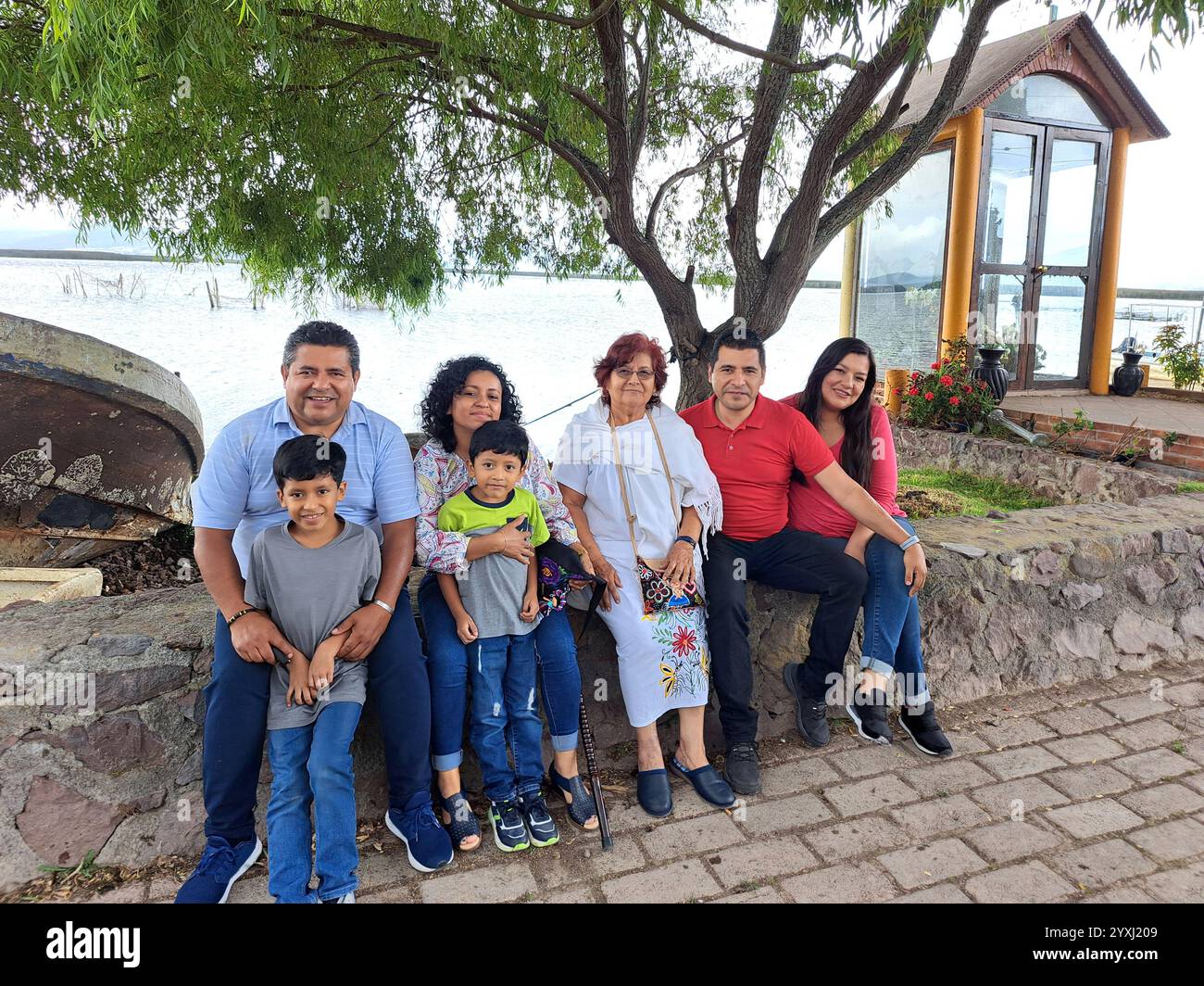 Traditional Latin family with grandmother, brothers and nephews spend a ...