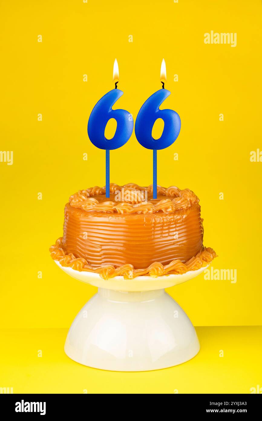 Number 66 candle - Happy Birthday Cake on a yellow background Stock ...