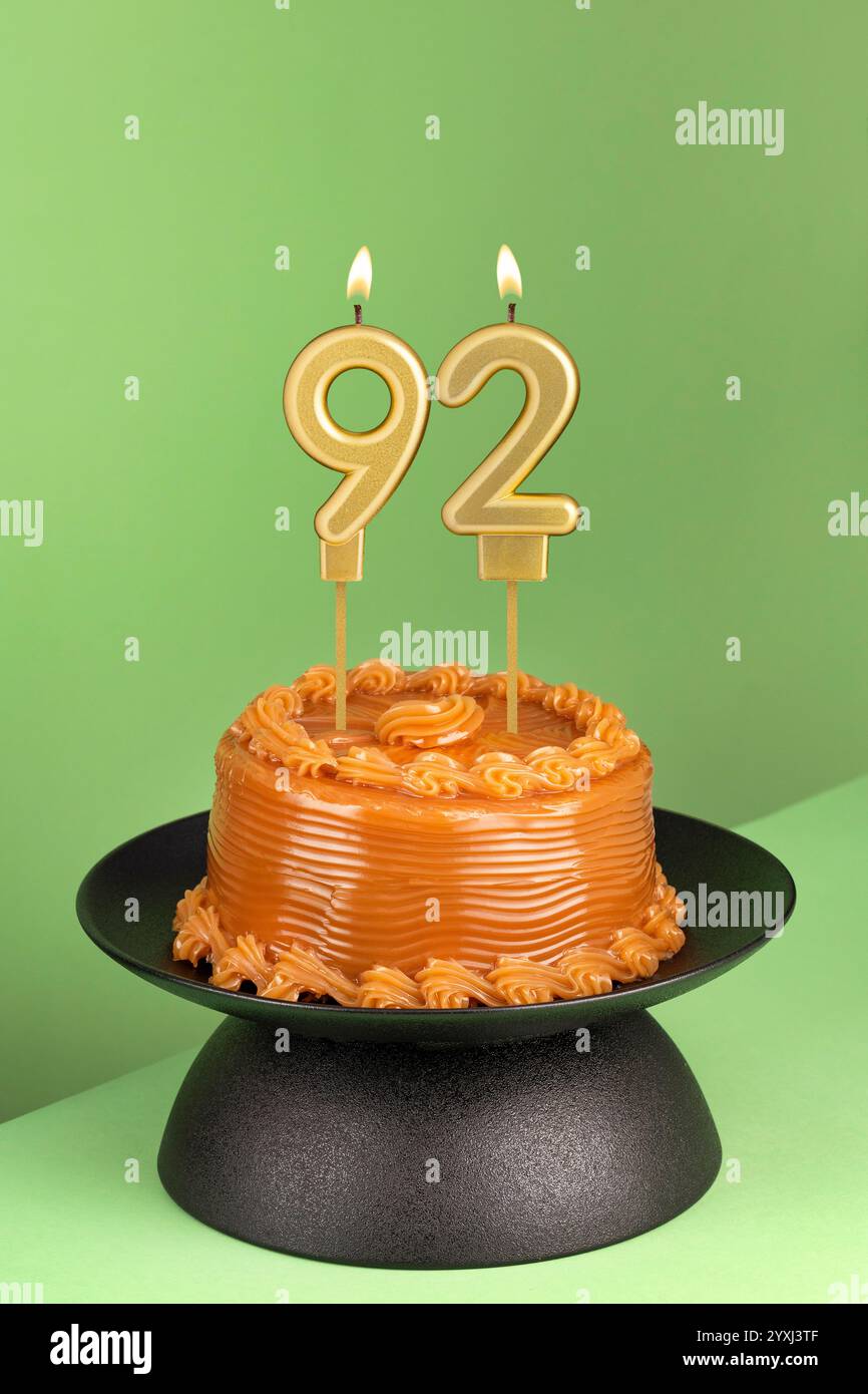 Delicious cake with dulce de leche - Number 92 birthday candle on a ...