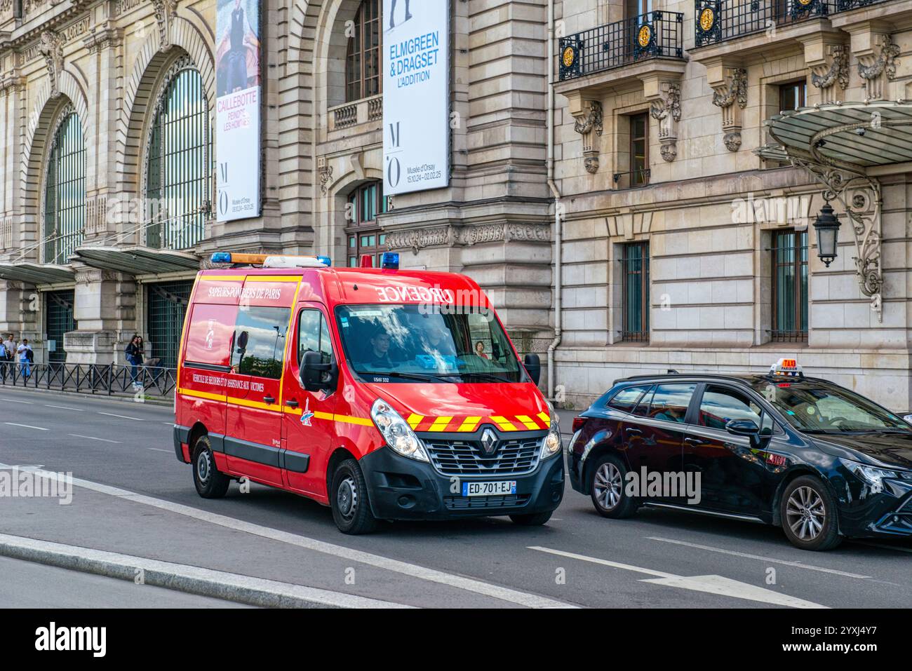 French fire truck with flashing blue lights makes it way through the ...