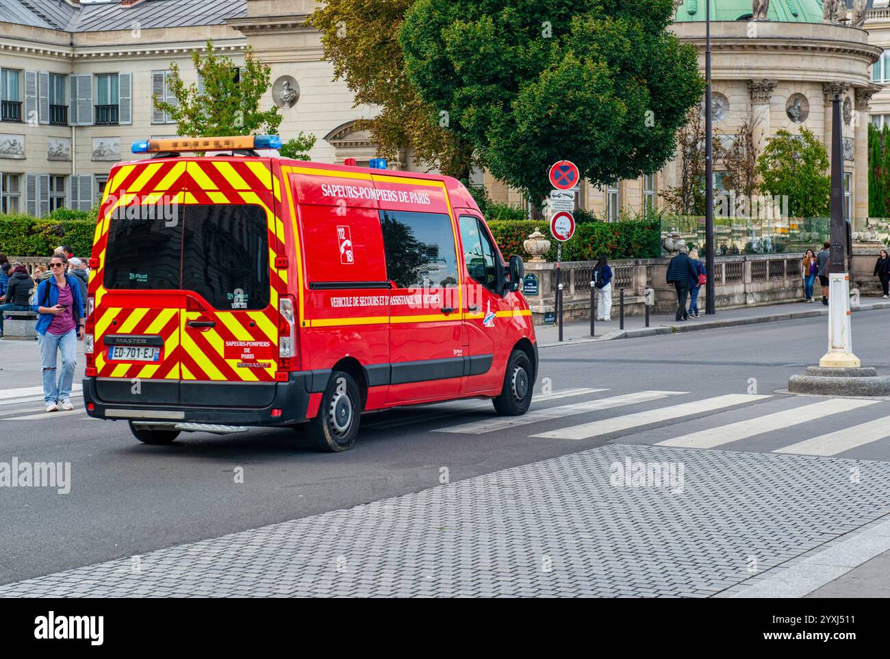 French fire truck with flashing blue lights makes it way through the ...