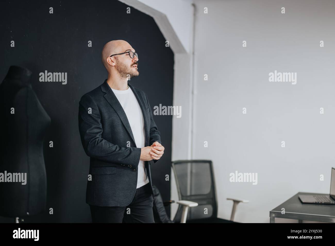 Fashion designer presenting new clothing ideas in a studio setting ...