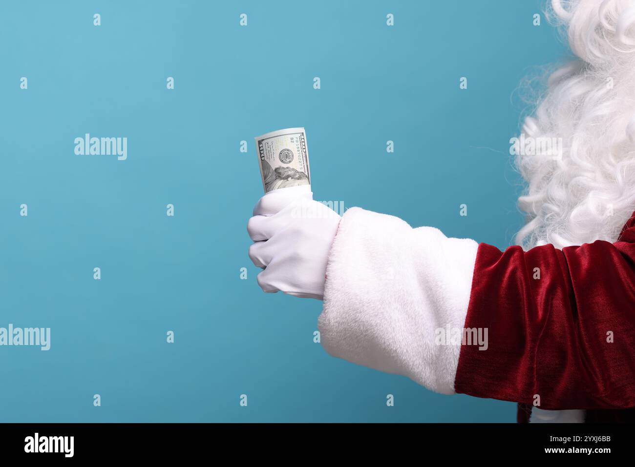 Santa Claus with dollar banknotes on light blue background, closeup ...