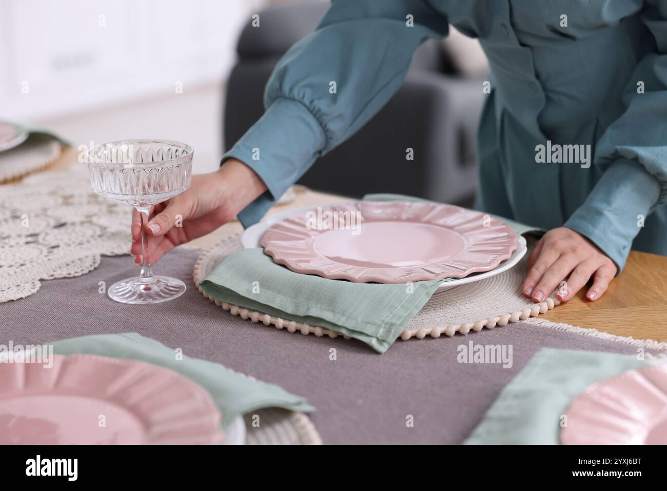Woman setting table for dinner at home, closeup Stock Photo - Alamy