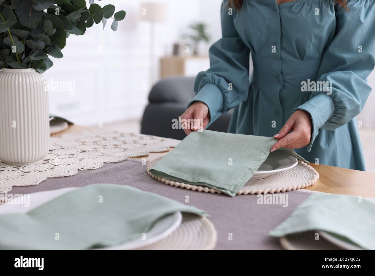 Woman setting table for dinner at home, closeup Stock Photo - Alamy