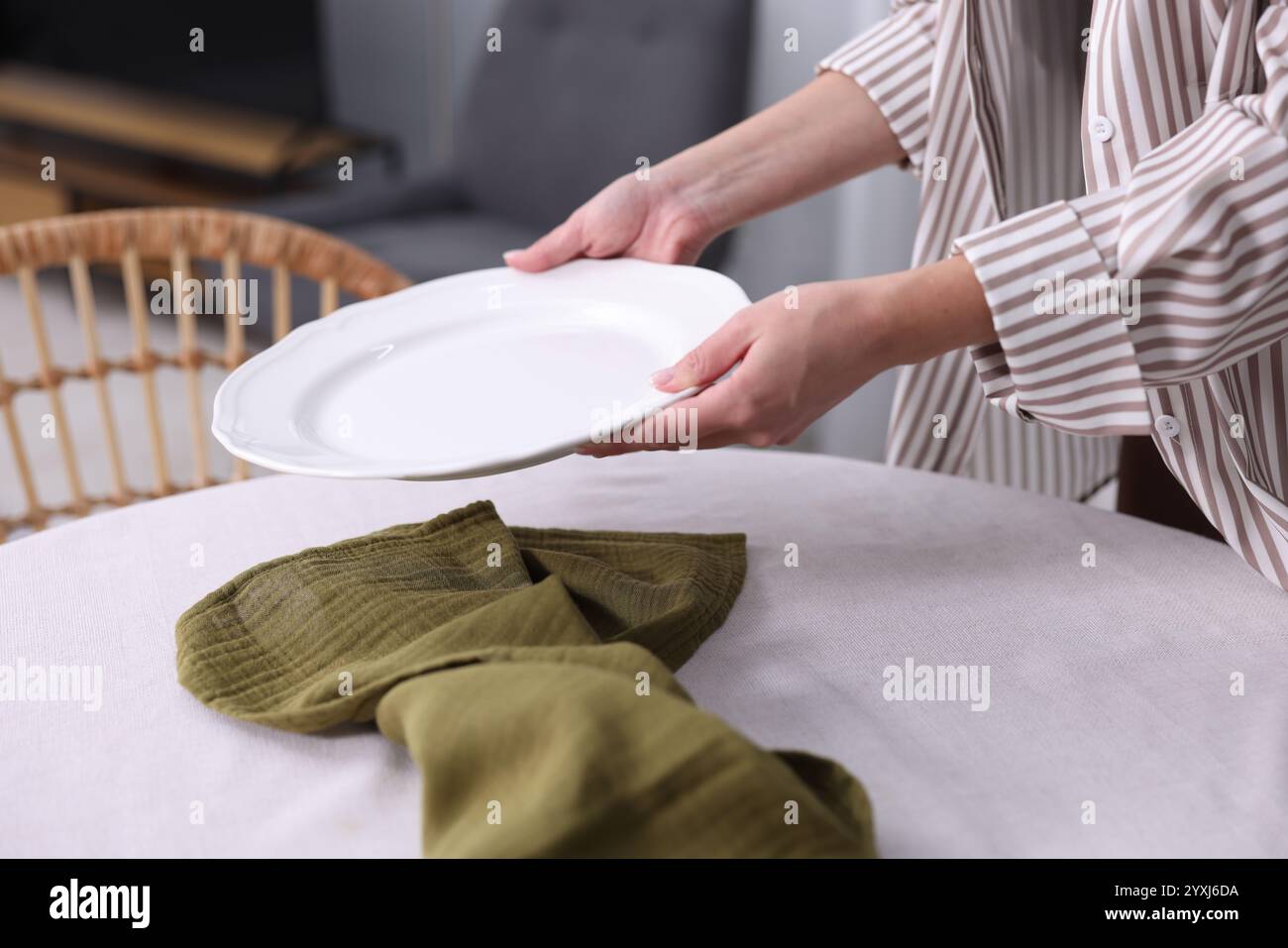 Woman setting table for dinner at home, closeup Stock Photo - Alamy