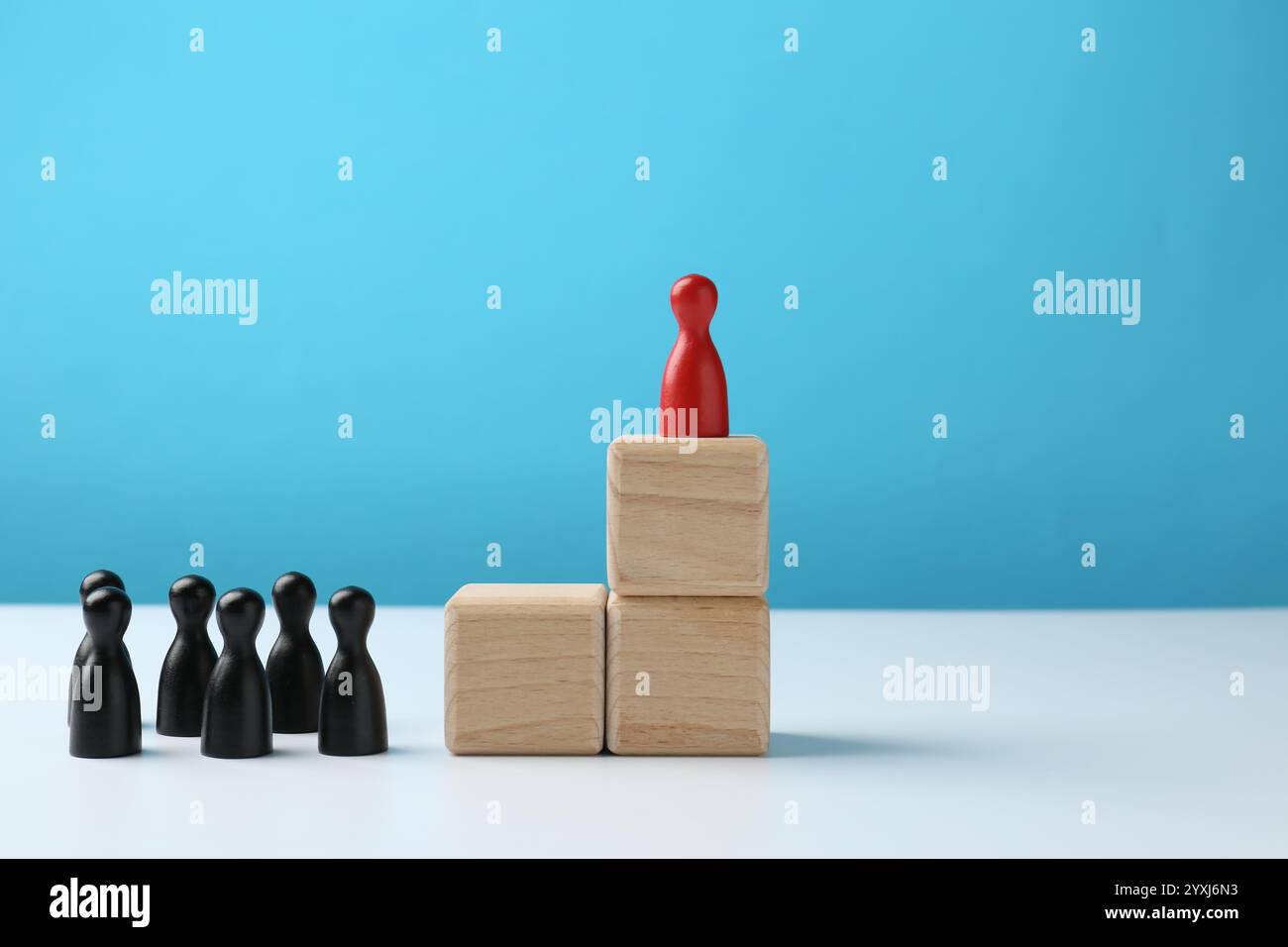 Black human figures in front of stacked wooden blocks with red figure ...