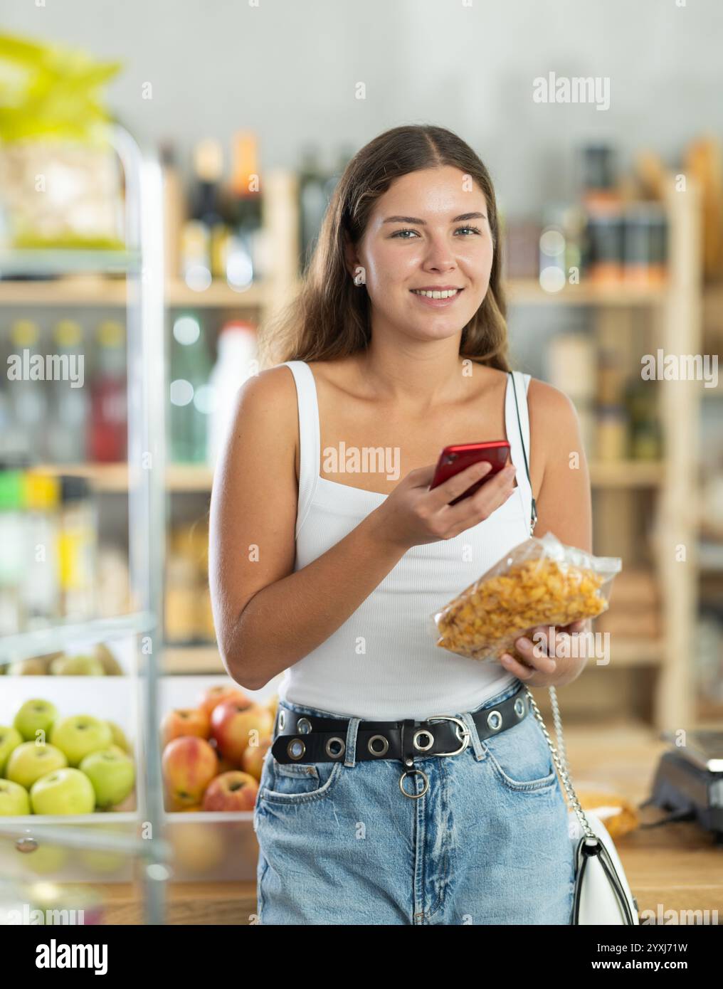 Young woman scanning qr code of corn flakes Stock Photo - Alamy