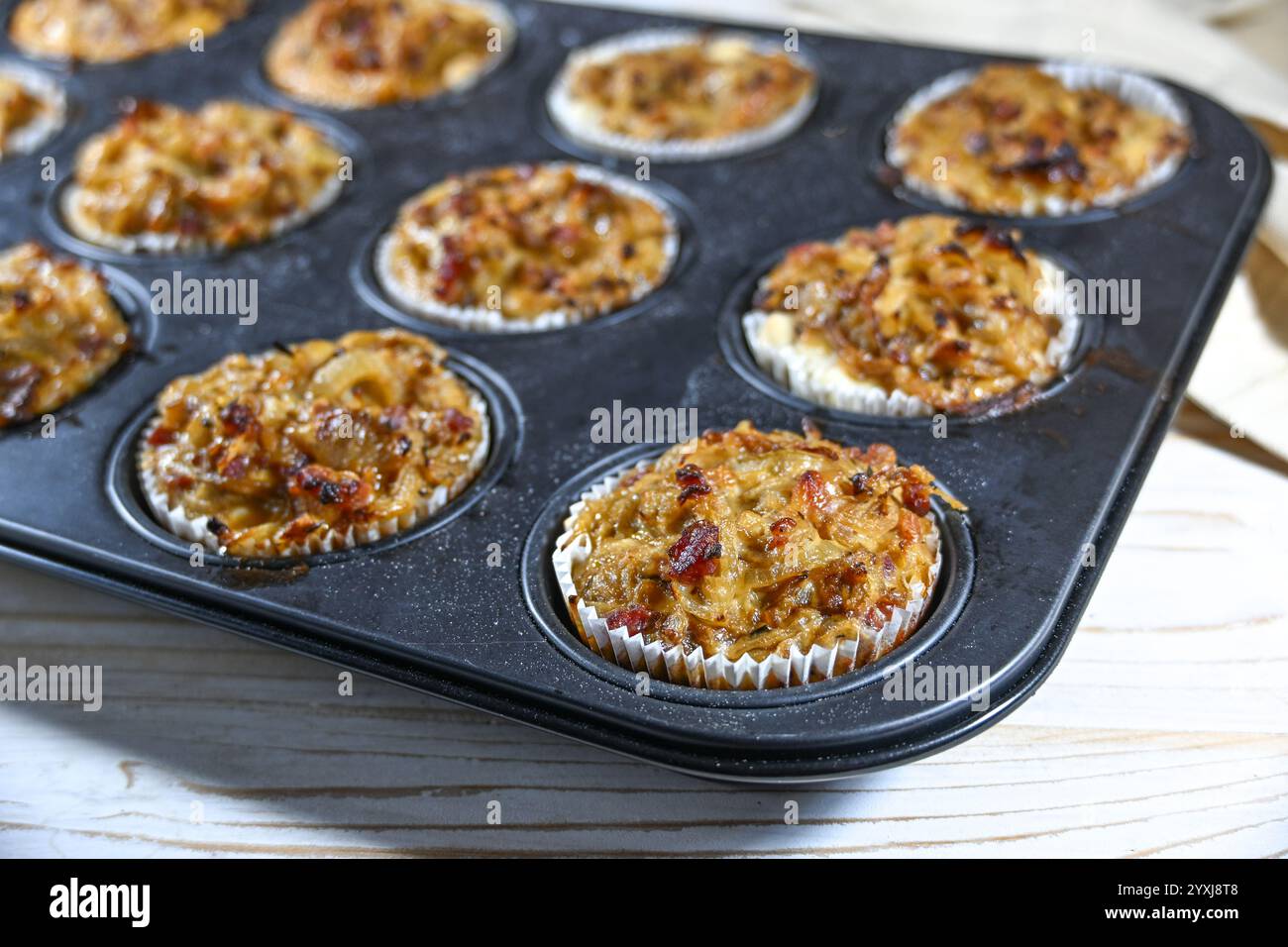 Savory muffins with onions and bacon freshly baked in a muffin tin ...