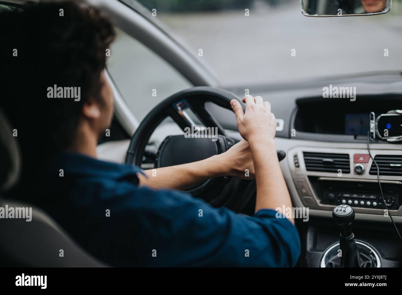 Man confidently driving a modern car on a clear road Stock Photo - Alamy