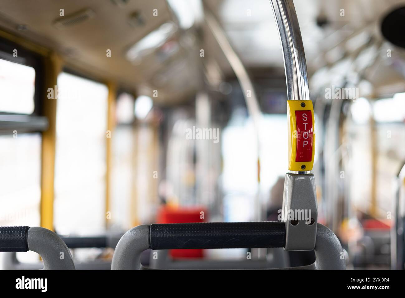Interior of public transport bus with emphasis on the stop button ...