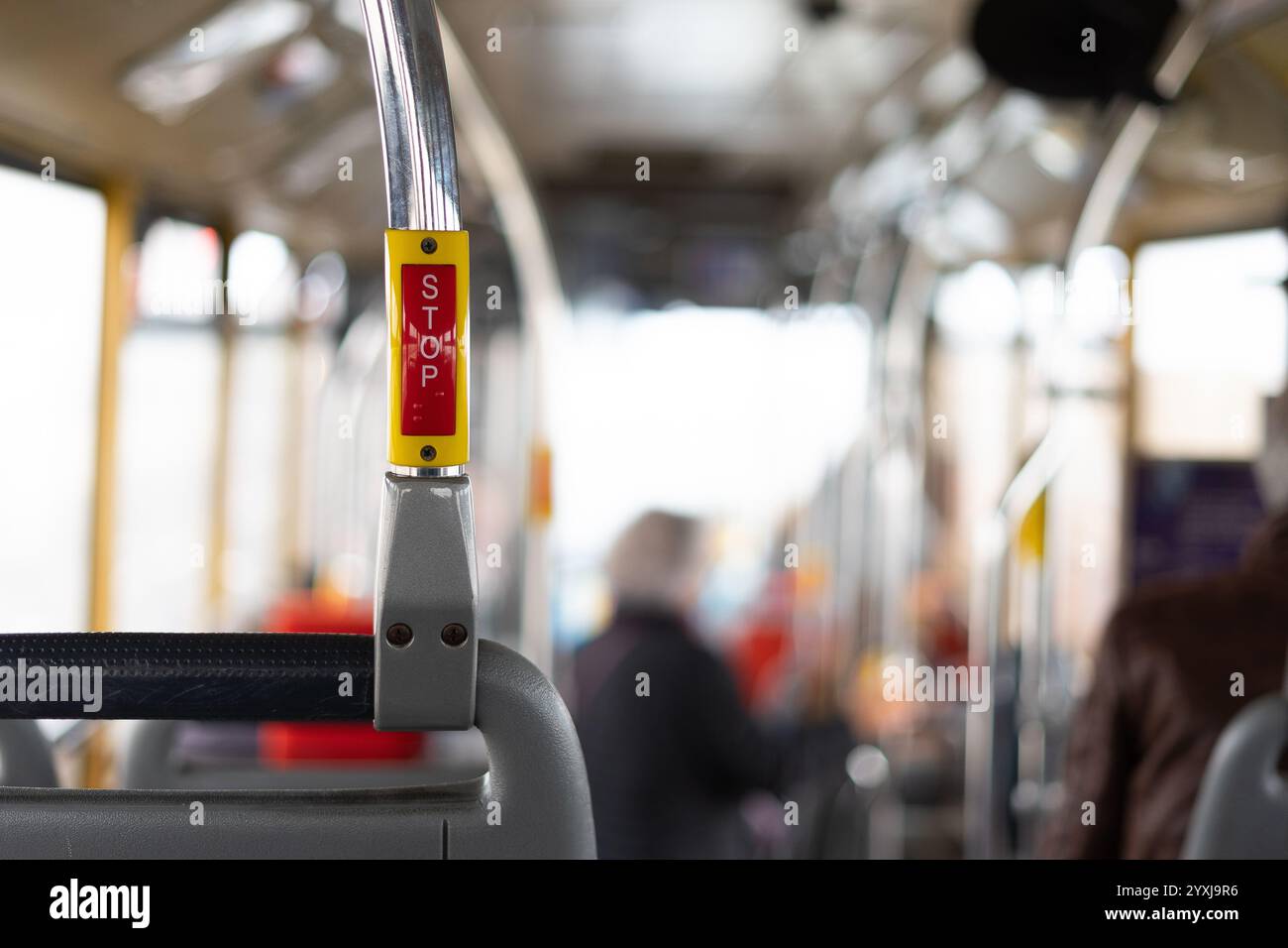 Interior of public transport bus with emphasis on the stop button ...