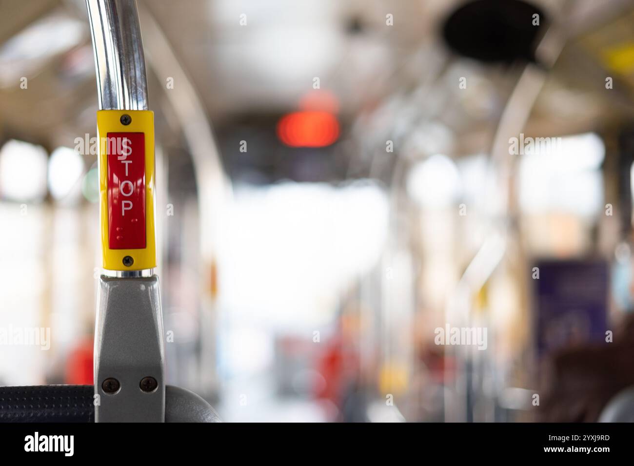 Interior of public transport bus with emphasis on the stop button ...