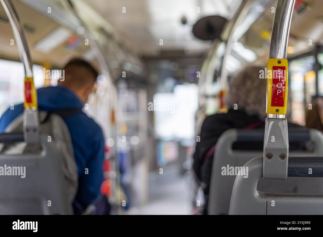 Interior of public transport bus with emphasis on the stop button ...