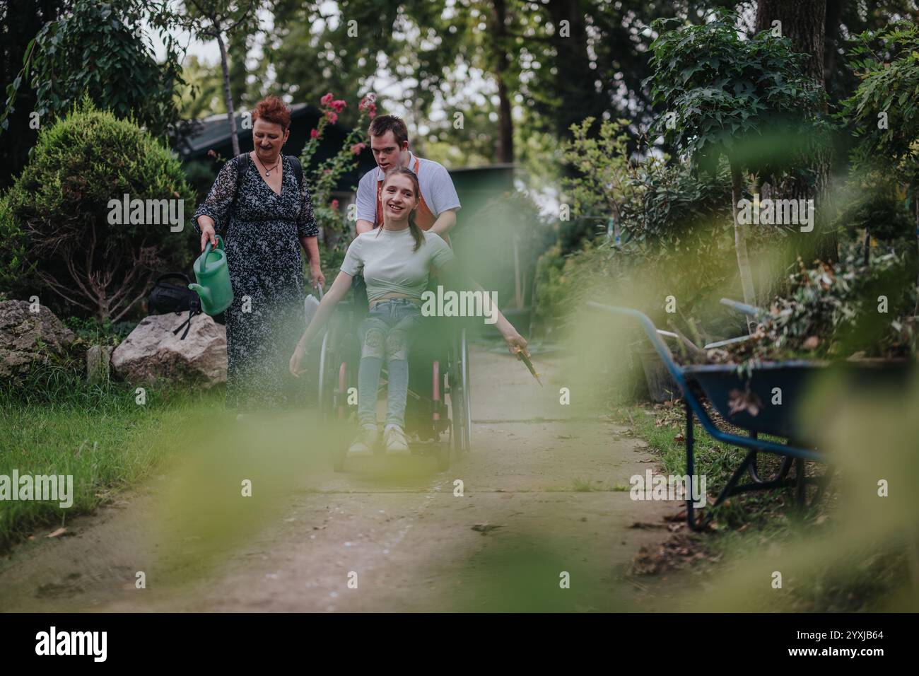 Family enjoying a joyful day in a lush garden pathway Stock Photo - Alamy