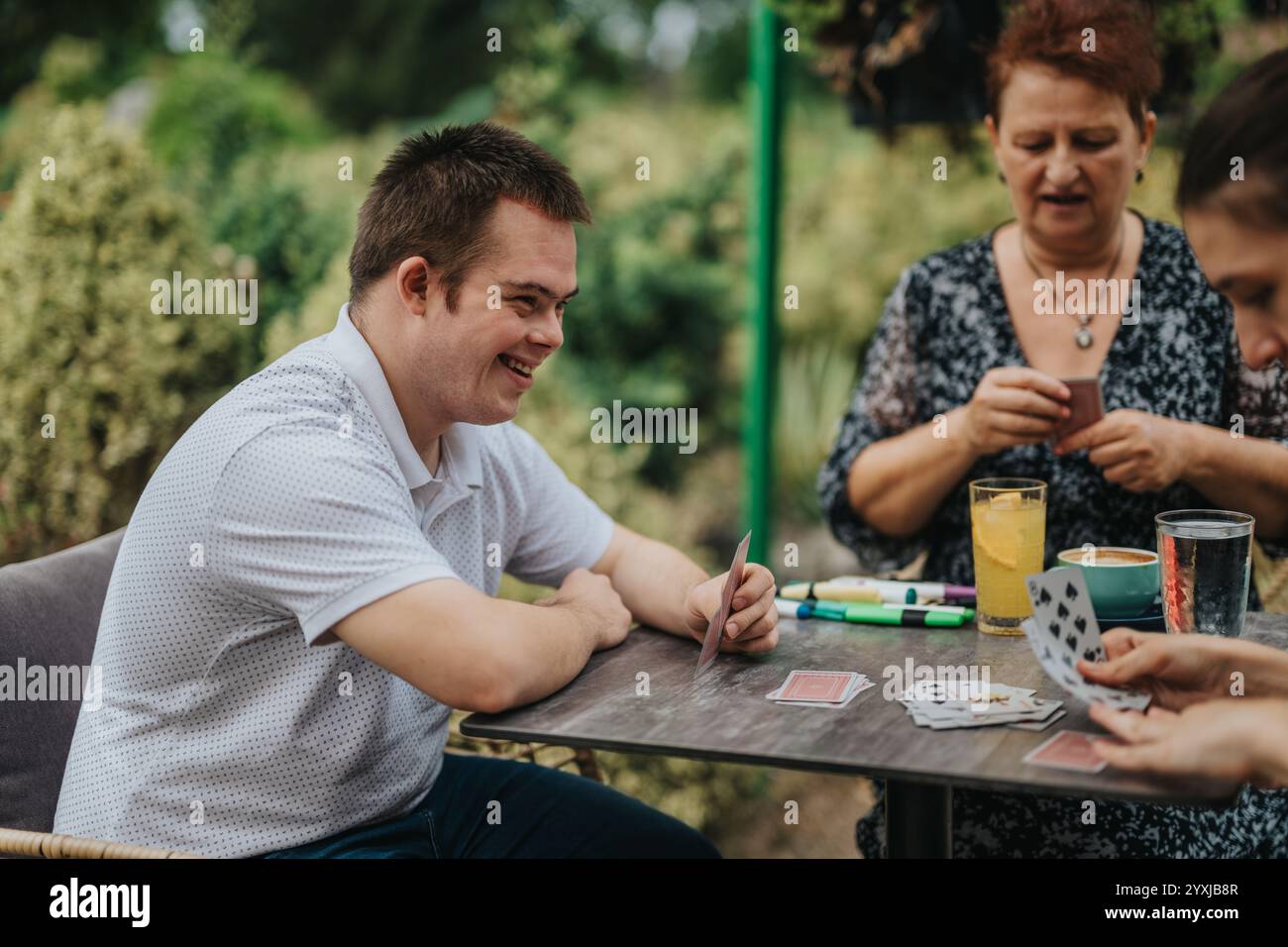 Family playing card game together in outdoor setting Stock Photo - Alamy