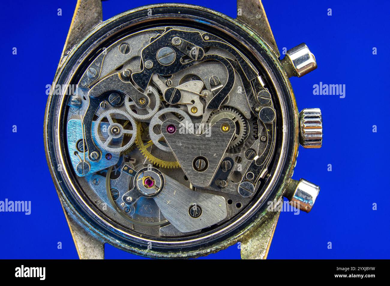 Old clock mechanism with blue incident light and blue background Stock ...
