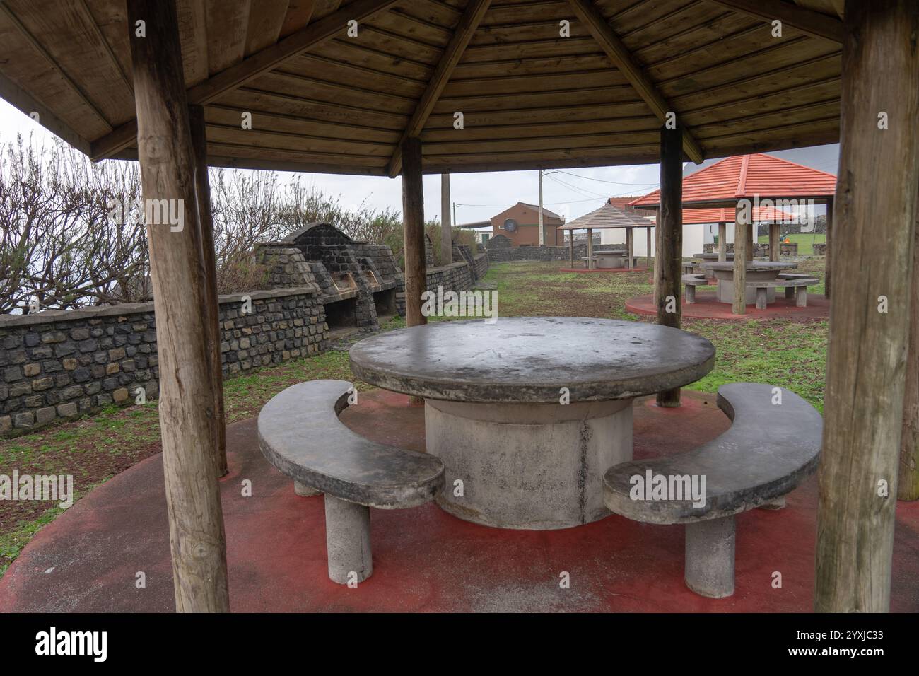 Stone table and benches in the picnic area on the island of flowers of ...