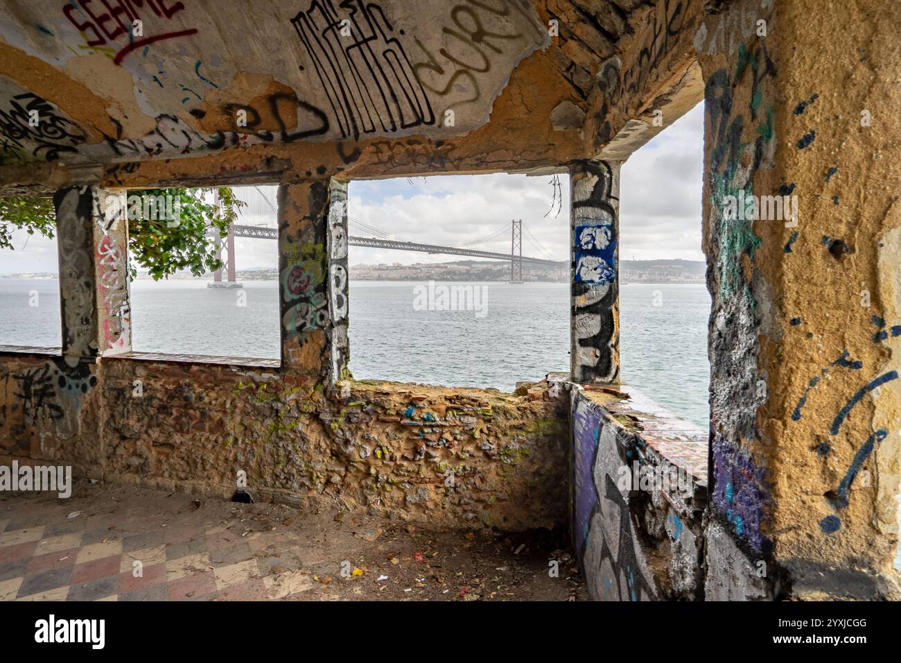ruins next to the Tagus River with a view of the 25 de Abril bridge ...