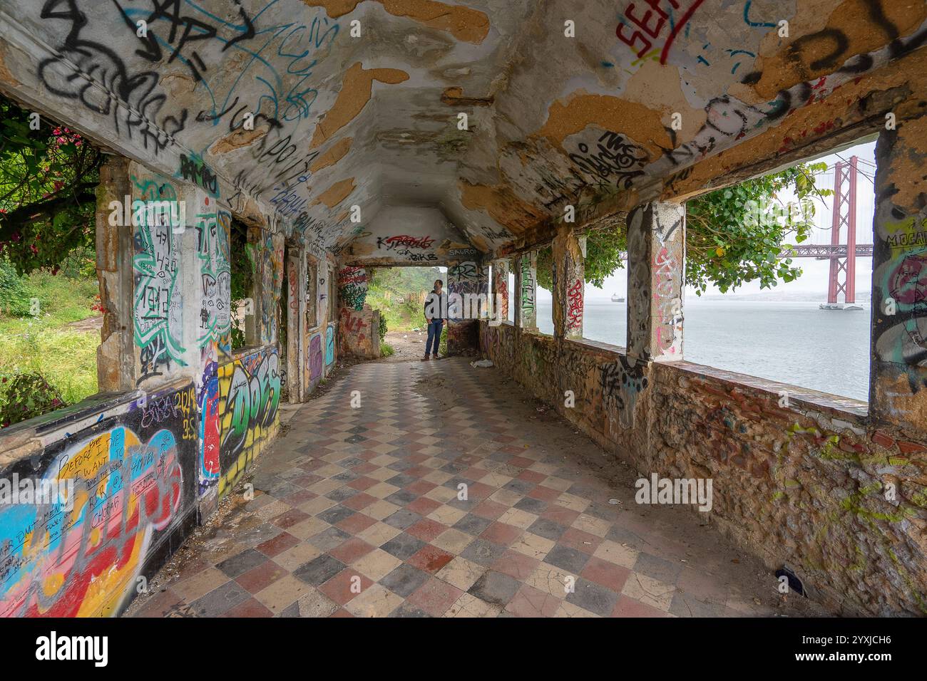 ruins next to the Tagus River with a view of the 25 de Abril bridge ...