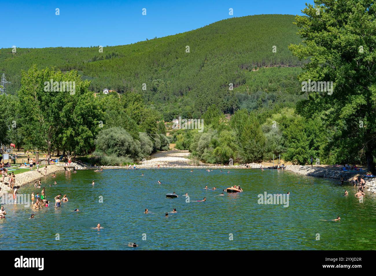 River beach in the town of Valhelhas surrounded by green mountains near ...
