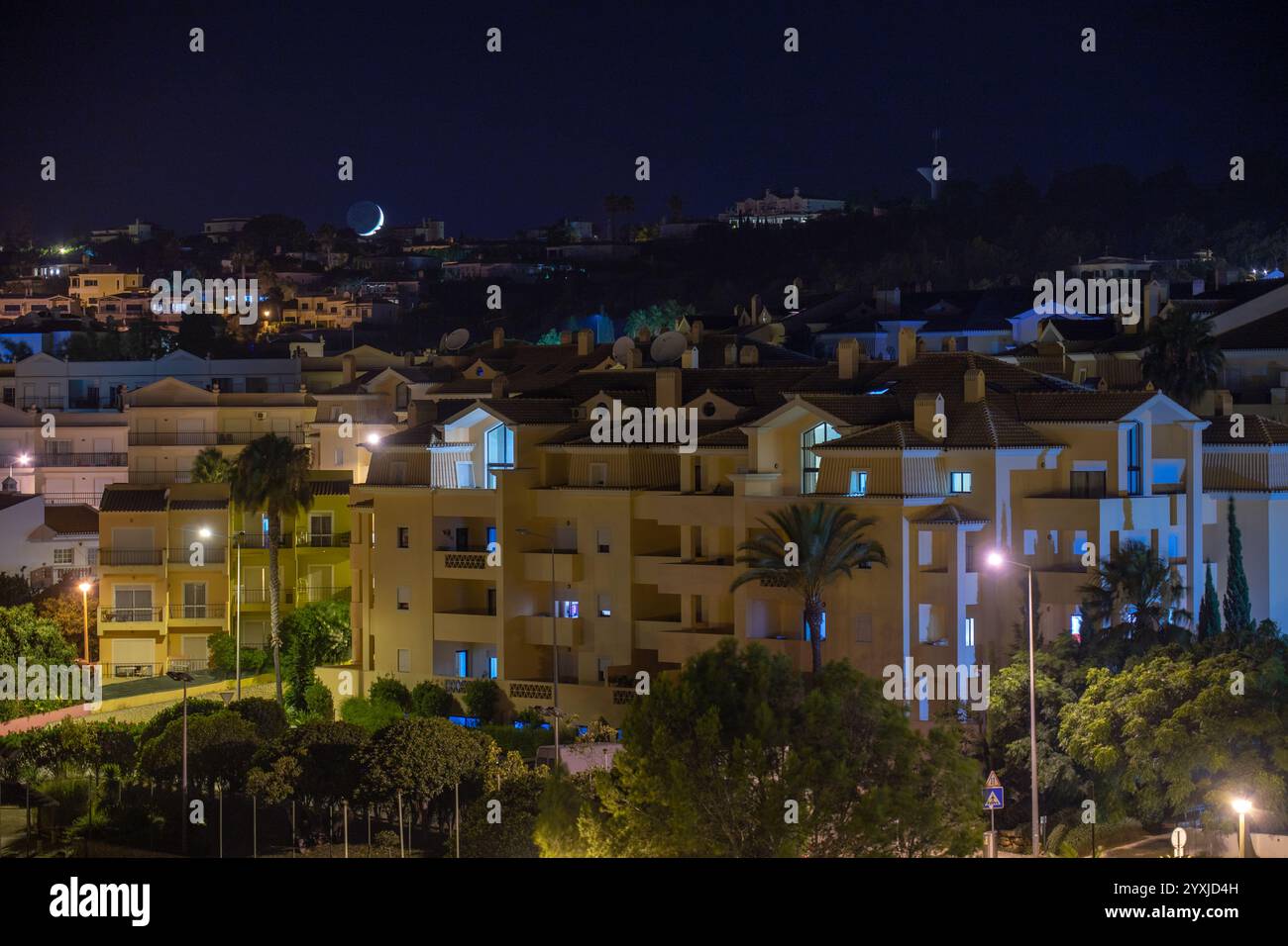 Night image with the crescent moon and lightning in the village of luz ...