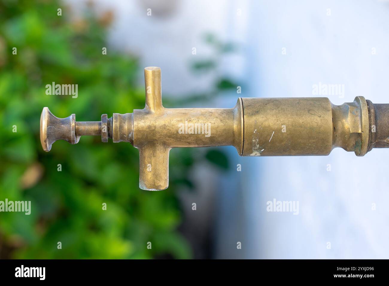 Outdoor push-button tap made of yellow brass Stock Photo - Alamy