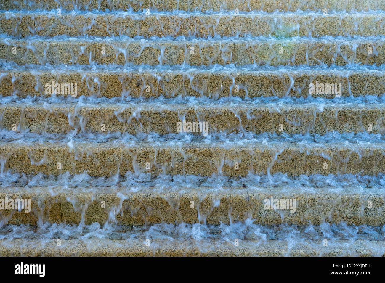 water running down stairs and forming foam passing through stone steps ...