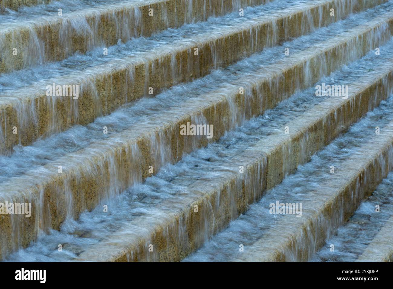 water running down stairs and forming foam passing through stone steps ...