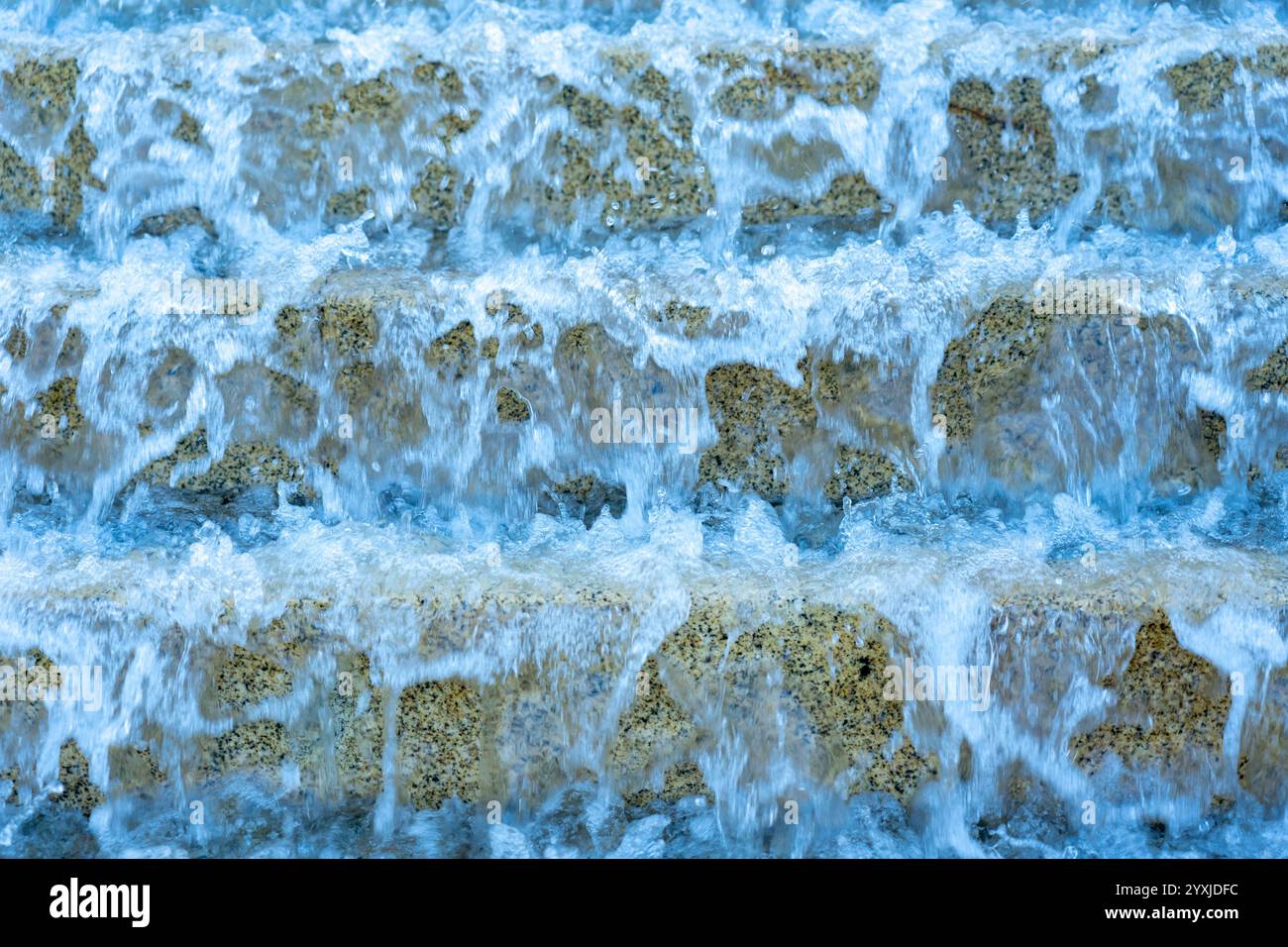 water running down stairs and forming foam passing through stone steps ...