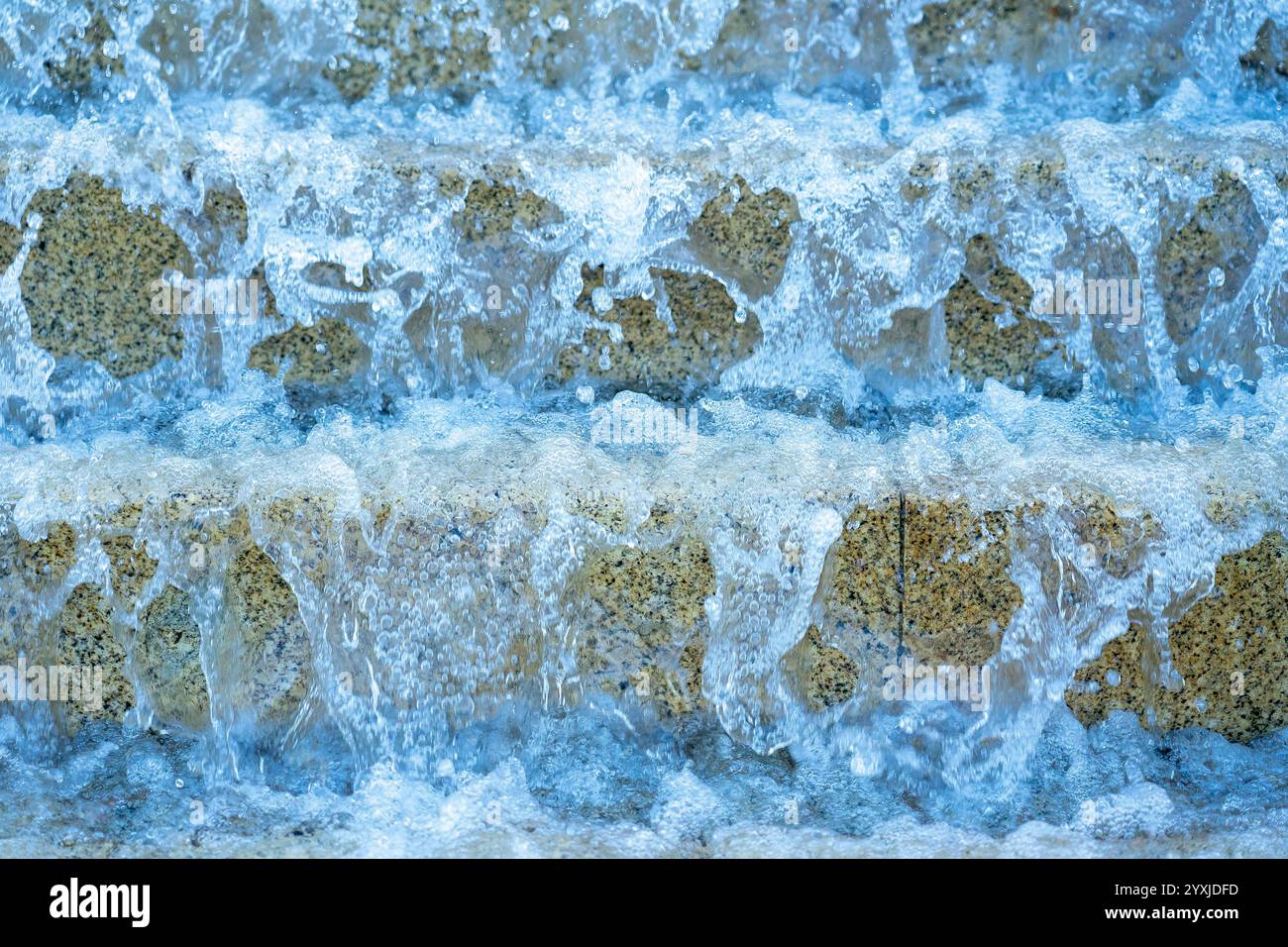 water running down stairs and forming foam passing through stone steps ...