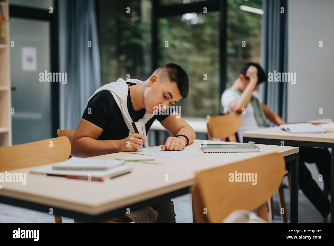 Focused students studying in a quiet classroom setting Stock Photo - Alamy