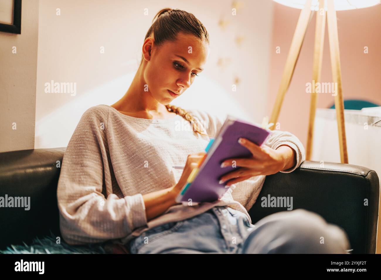 Focused college student studying at home in cozy setting Stock Photo ...
