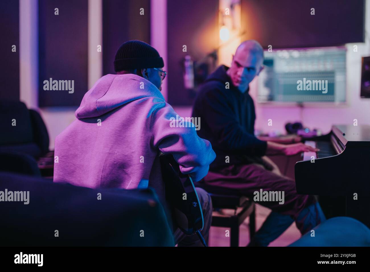 Musicians collaborating in a modern recording studio with vibrant ...