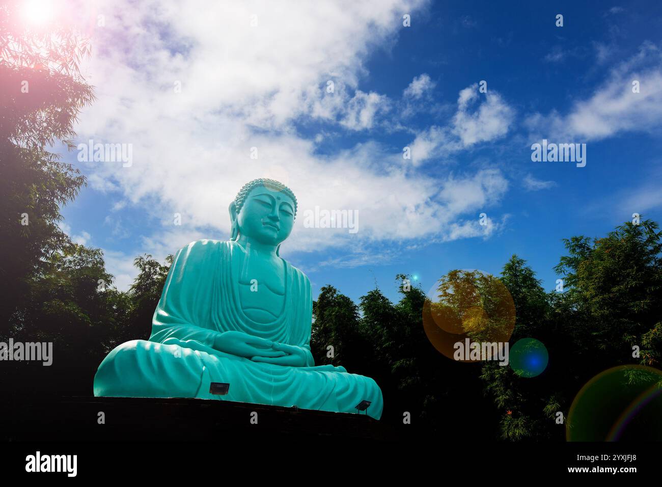 Sunlight shines through the back of a green Japanese-style Buddha ...