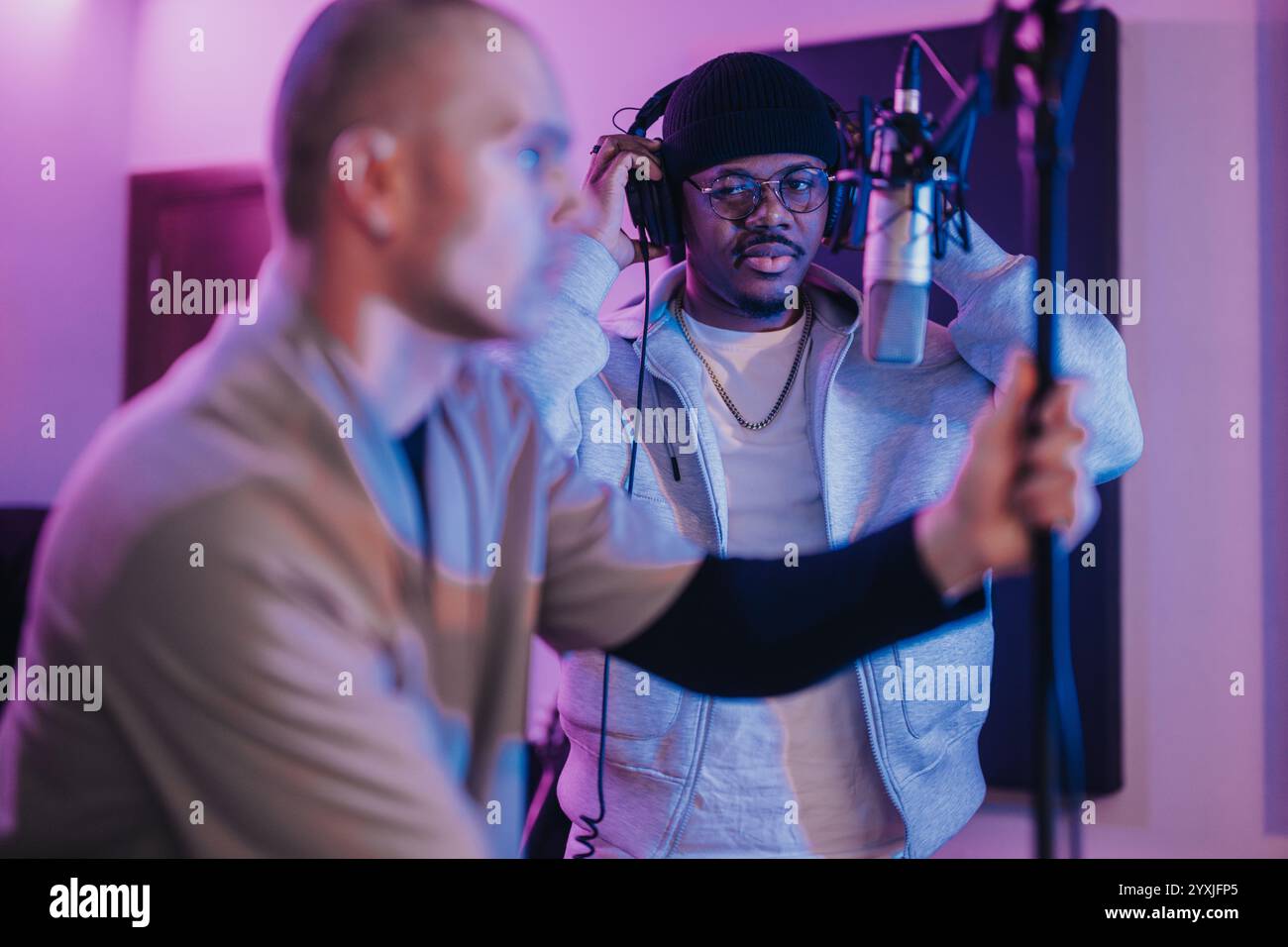 Multiracial musicians collaborate in a modern recording studio with ...