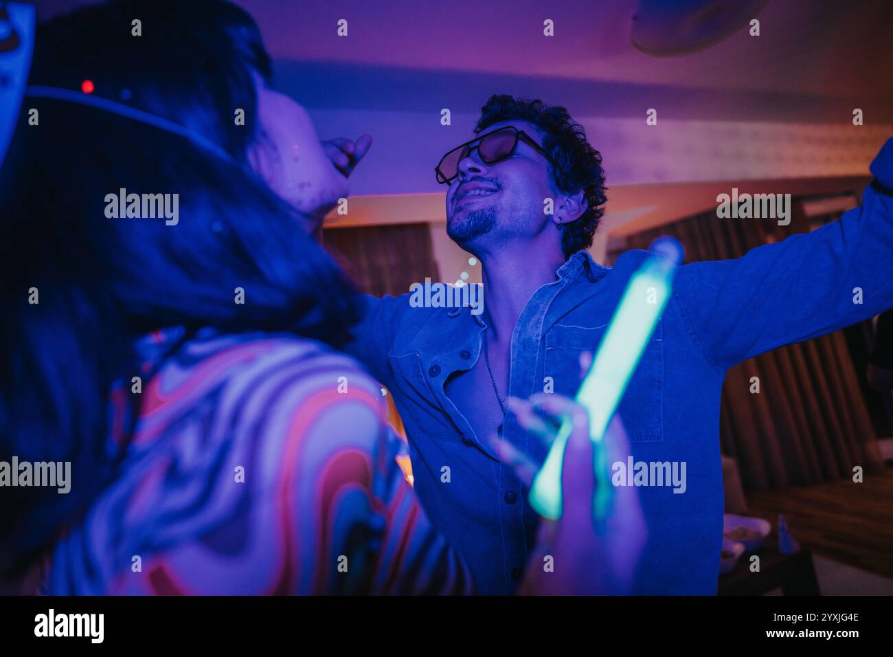 A vibrant birthday party scene with friends dancing energetically under ...