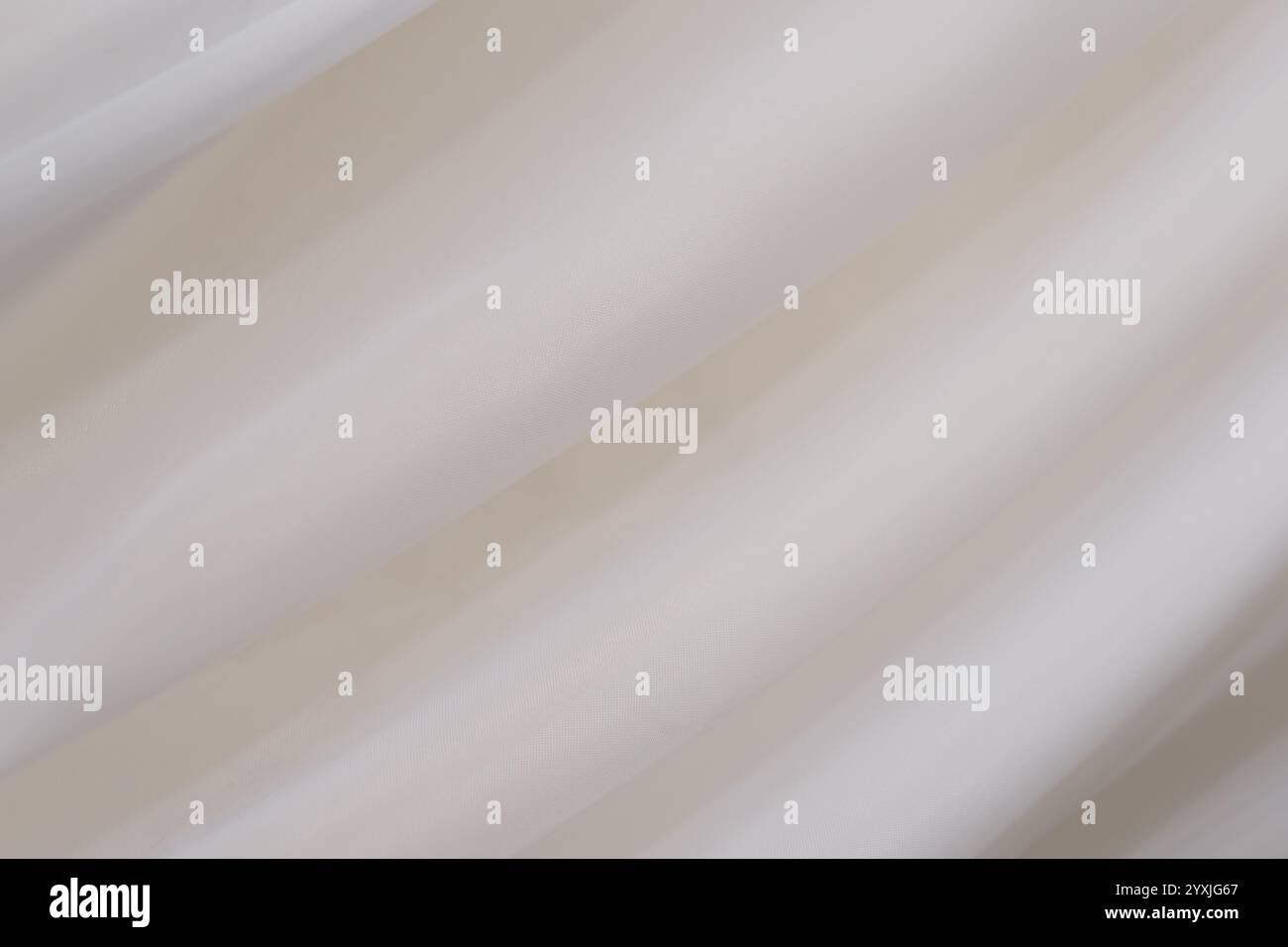 Delicate fabric falls gracefully across a smooth surface, capturing the ...